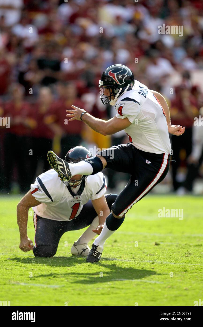 Houston Texans holder Matt Turk (1) and kicker Neil Rackers (4) follows ...