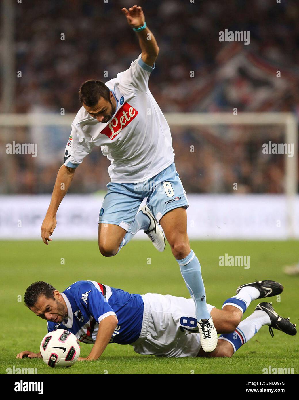 Napoli defender Andrea Dossena, top, jumps over Sampdoria defender ...