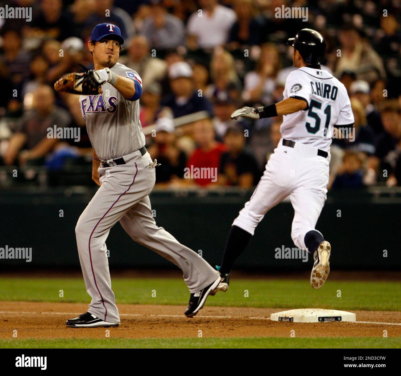 Texas Rangers' Jorge Cantu, left, looks back as Seattle Mariners ...