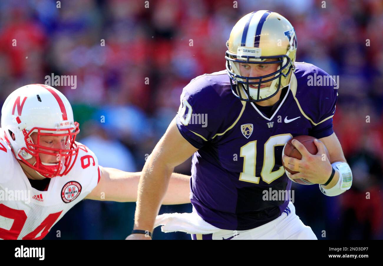 Washington quarterback Jake Locker (10) is chased by Nebraska's Jared ...