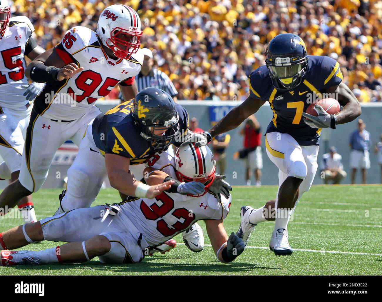 West Virginia's Noel Devine, right, runs away from Maryland's Alex ...