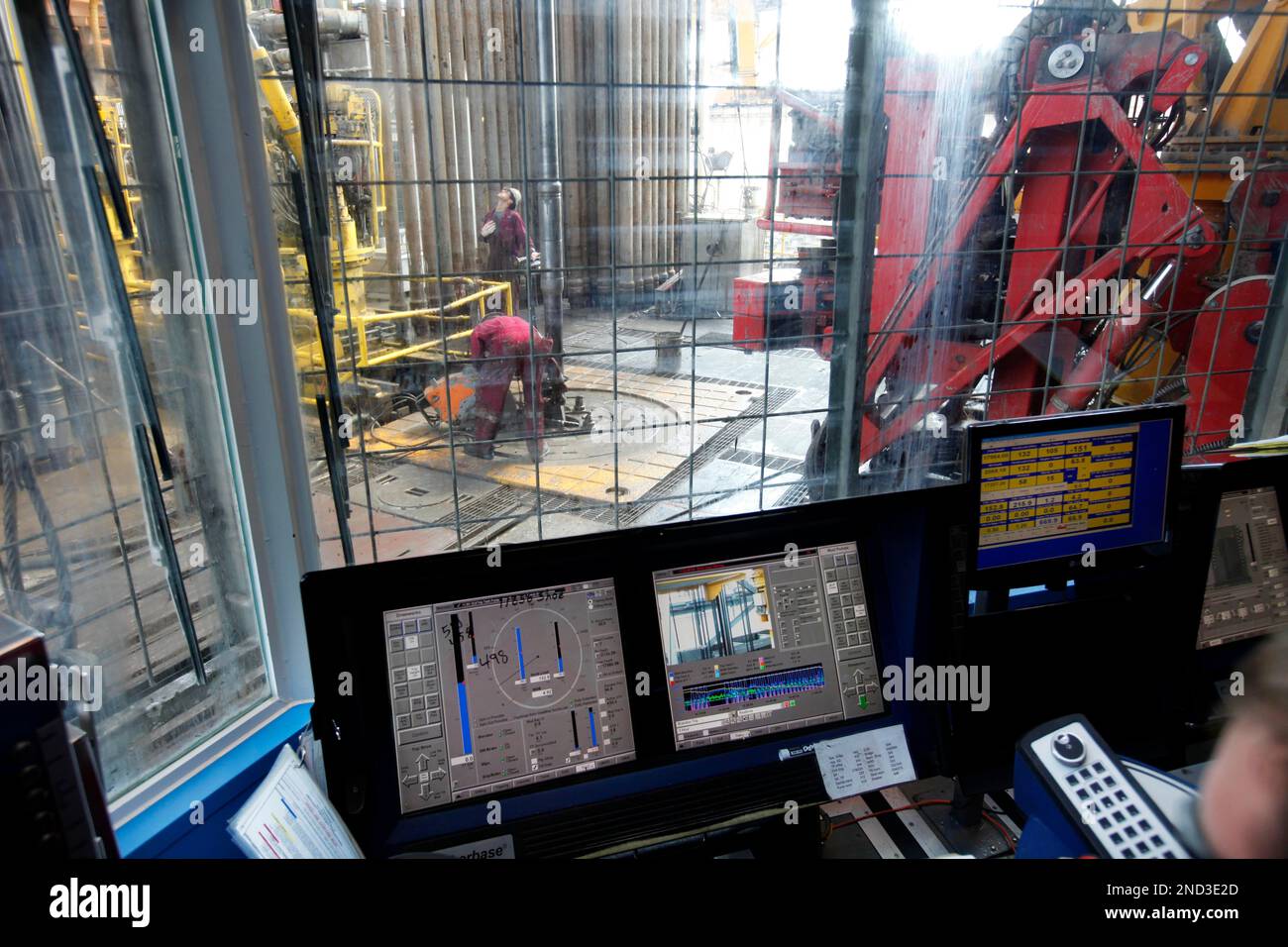 Workers on the drilling floor are seen on from the window of the ...