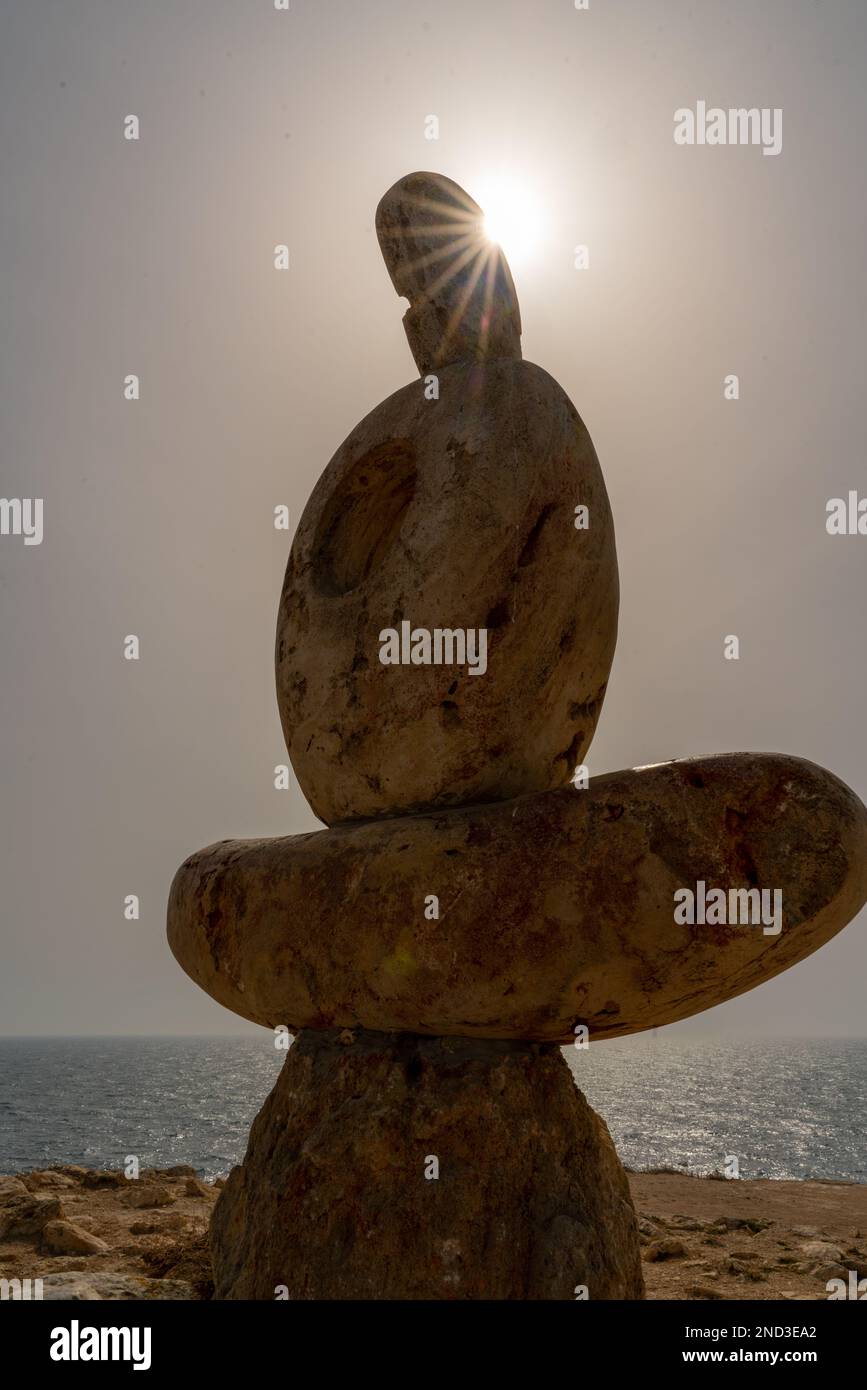 Sculpture symbol made of large pebbles against the blue sky Stock Photo ...