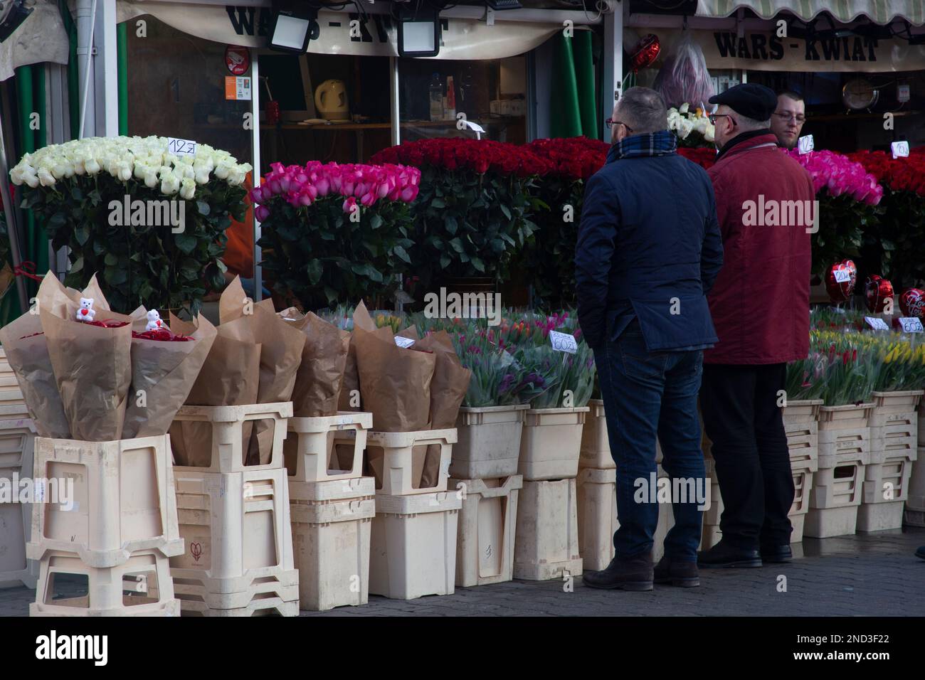 Two men selected roses for Valentine's day outside Hala Mirowska market ...