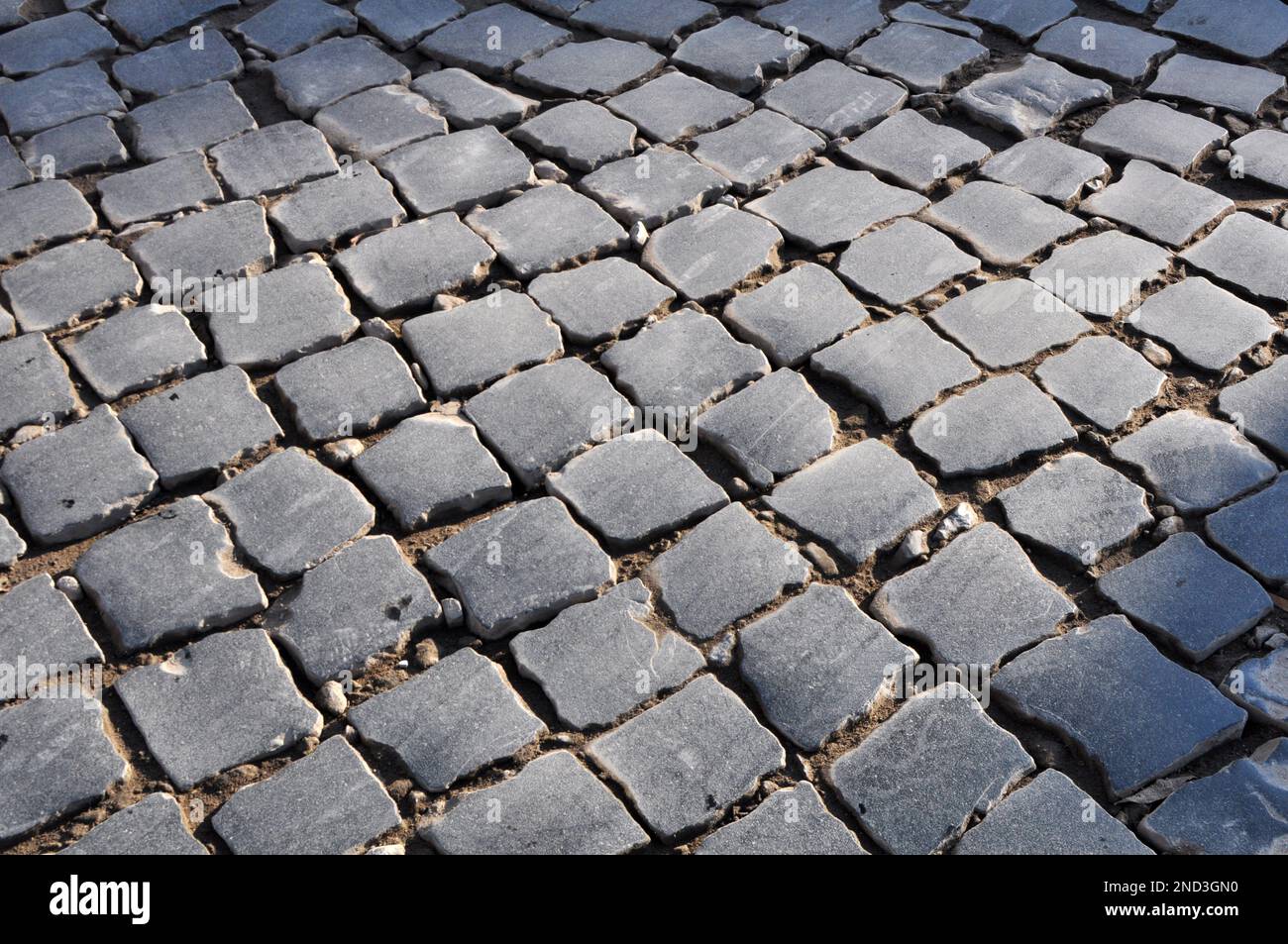 Old stone cobblestones from which the road is paved Stock Photo - Alamy