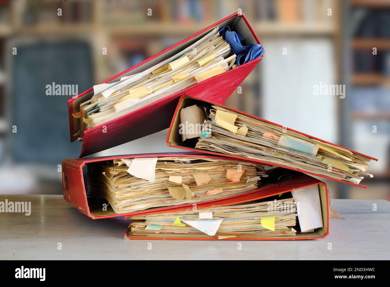 stack of dusty messy file folders with narrow depth of field, blurred ...