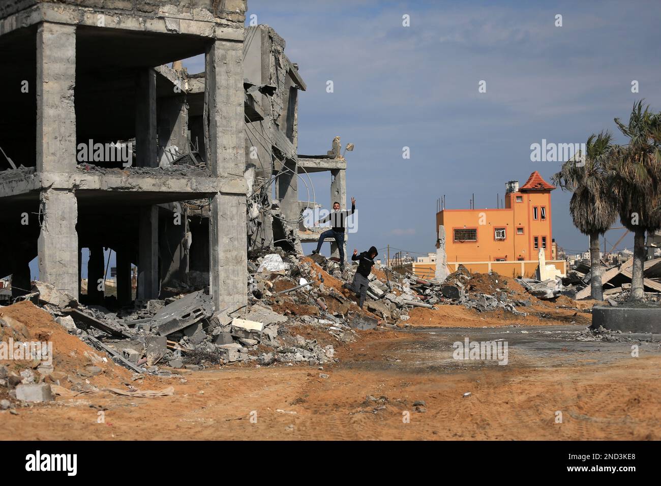 Palestinians inspect a wedding hall that was damaged in the aftermath ...