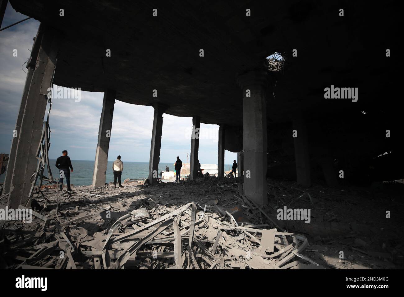 Palestinians inspect a wedding hall that was damaged in the aftermath ...