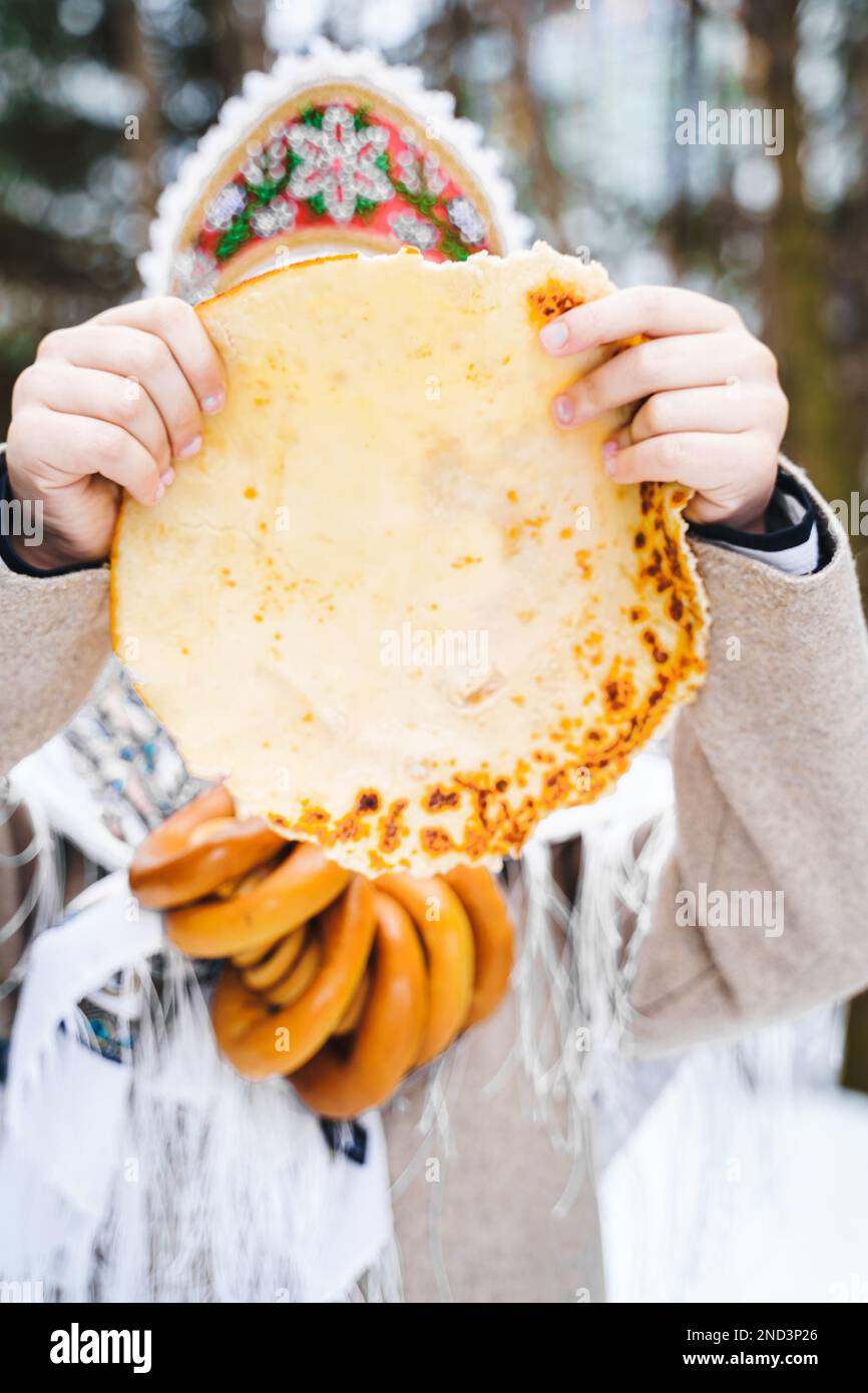 Russian national festival Maslenitsa, shrovetide. Little cute beautiful ...