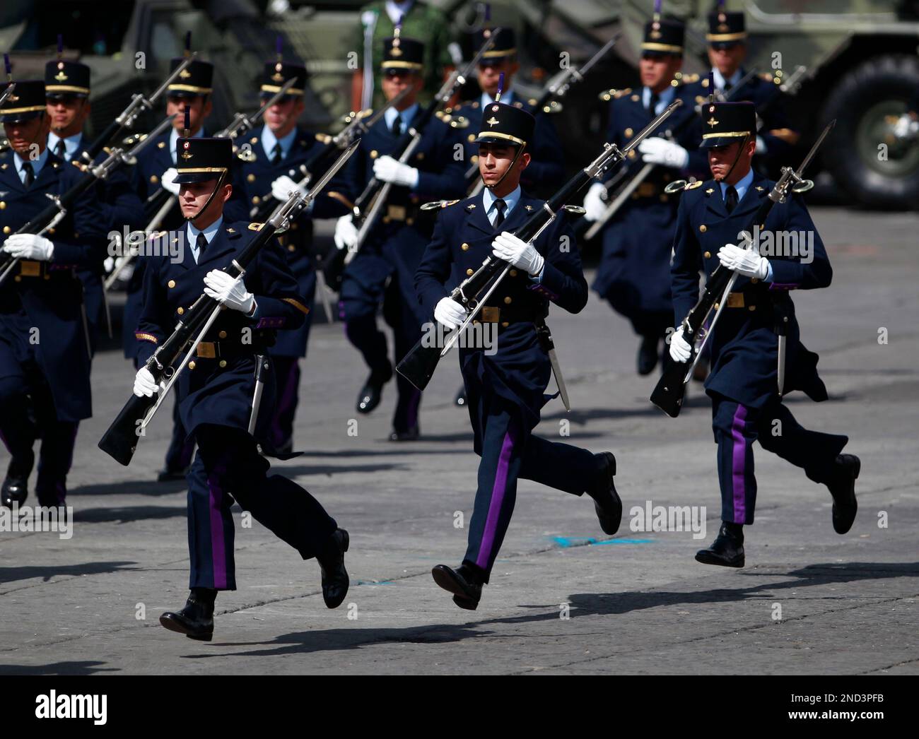 Mexican army soldiers, wearing their gala uniforms, run during the ...