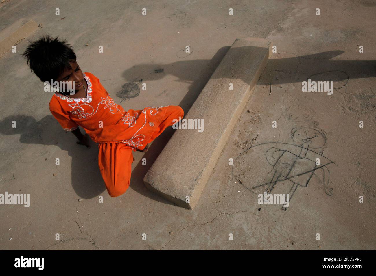 A Pakistani girl who survived floods plays at a temporary shelter set ...