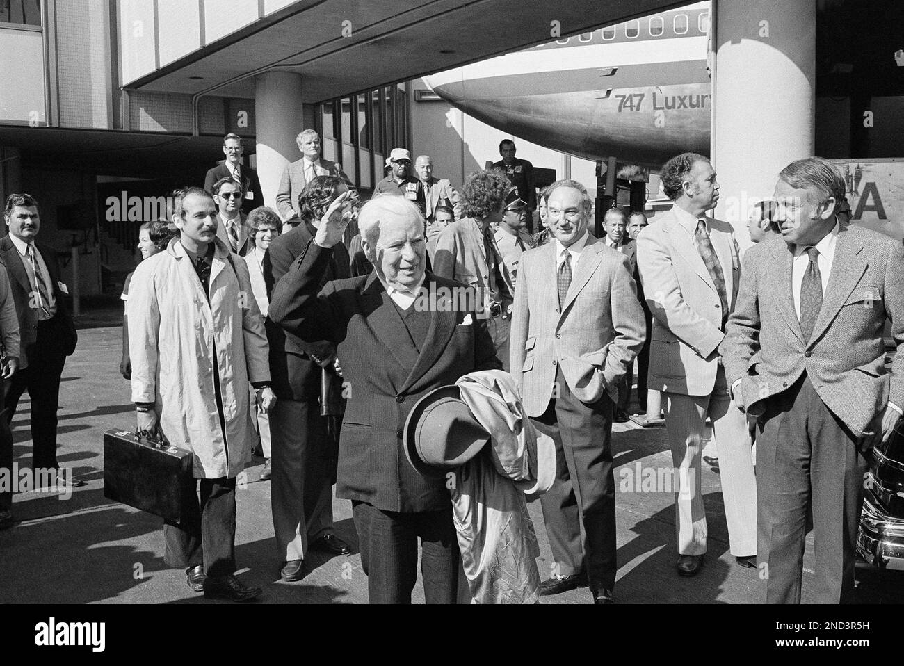 Comedian Charlie Chaplin, 82, waves to newsmen as he arrived at Los ...