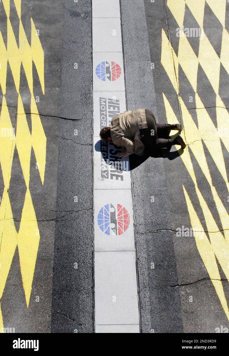 New Hampshire Motor Speedway general manager Jerry Gappens kneels down ...