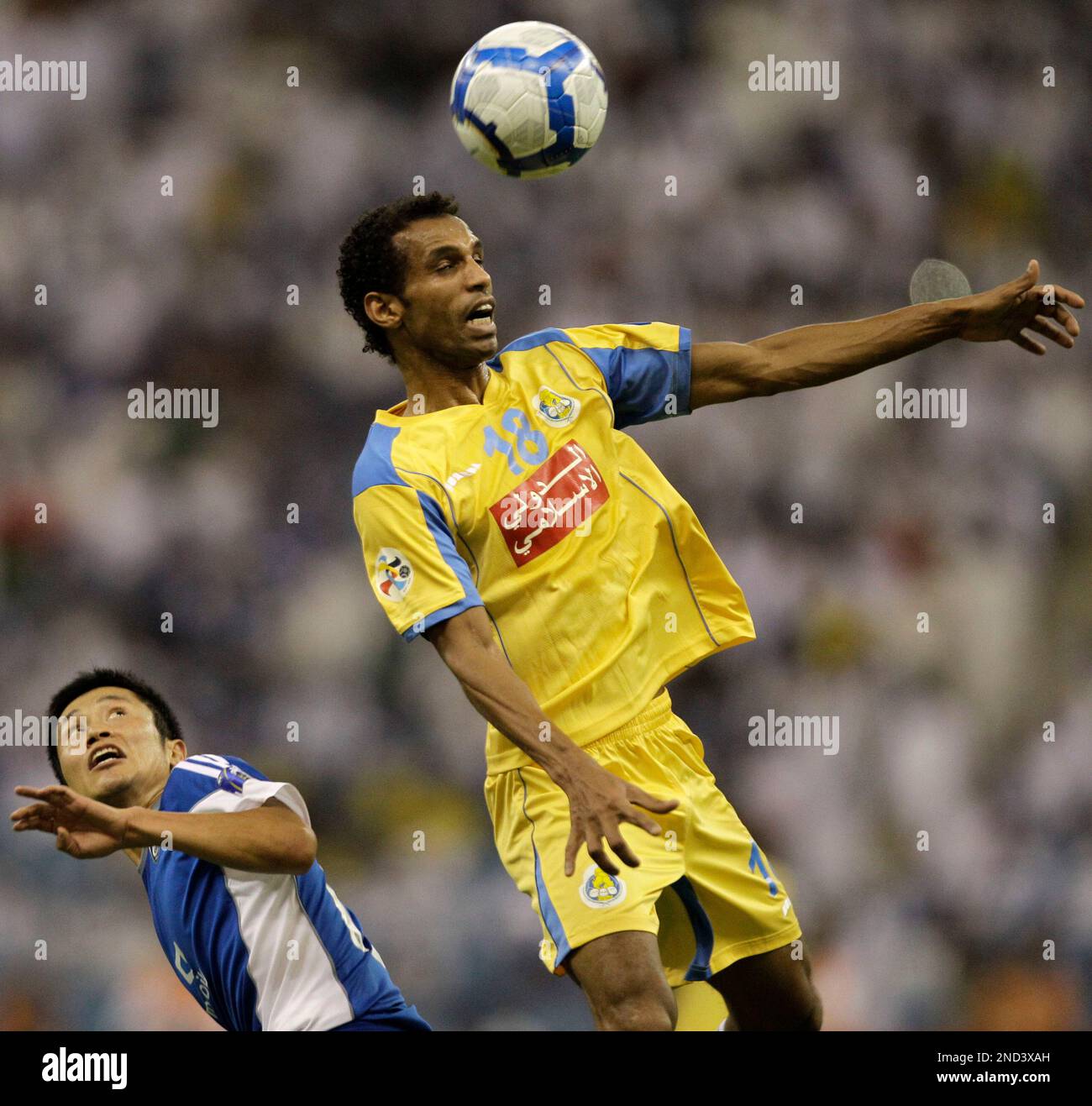 Saudi's Al-Hilal player Lee Young-Pyo, left, fights for the ball ...