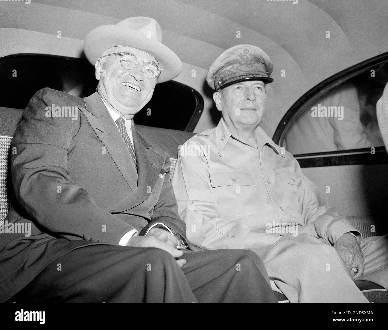 President Harry Truman and Gen. Douglas MacArthur sit in the back seat ...