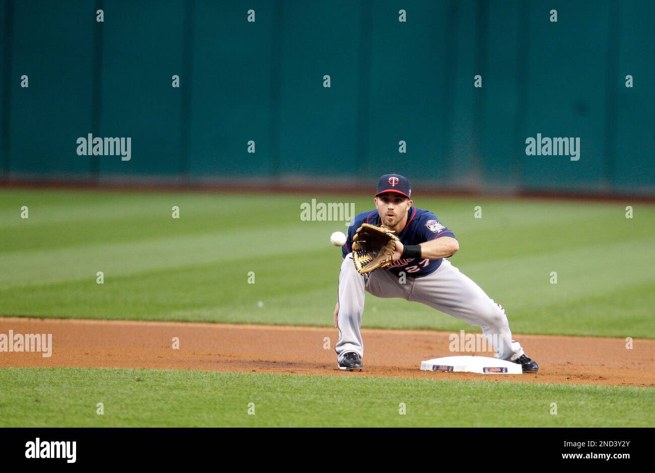 Minnesota Twins shortstop J.J. Hardy fields a ball in a baseball game ...