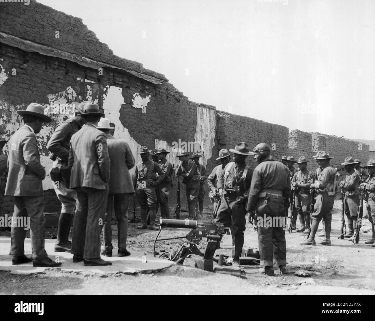 Machine gun being set up by troops of the 10th. United States cavalry ...