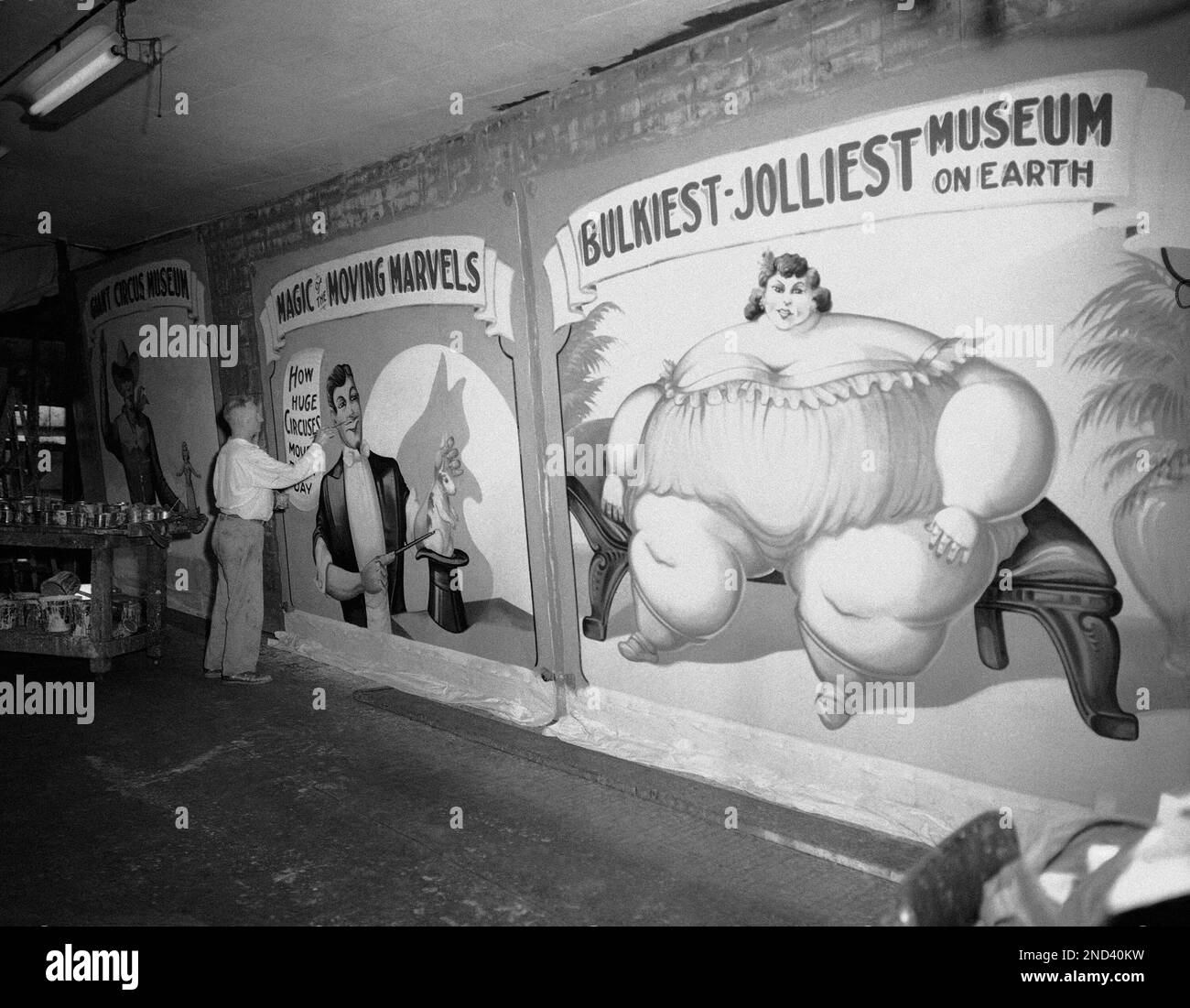 Fred Johnson, 67, a banner artist of the old school, puts the final ...