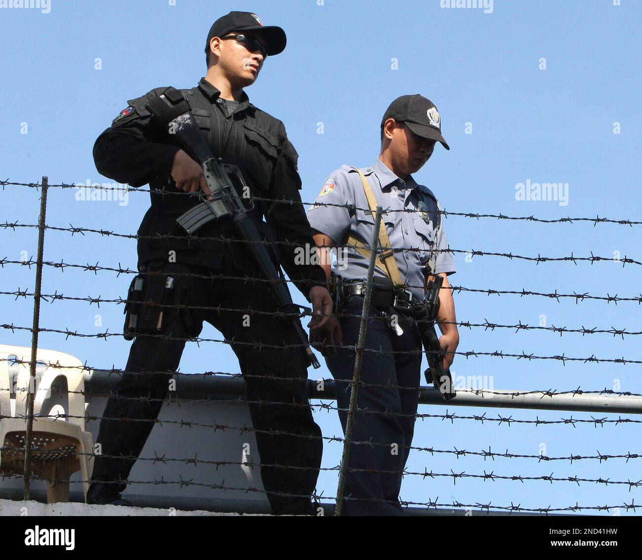 A SWAT member of the Philippine National Police, left, conducts joint ...
