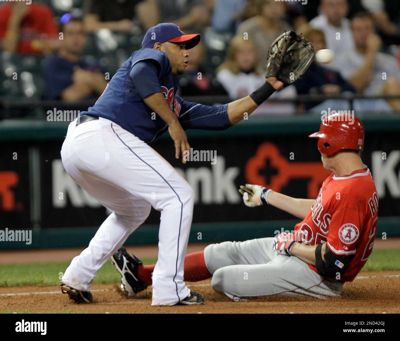 Los Angeles Angels' Peter Bourjos, right, slides past Cleveland Indians ...