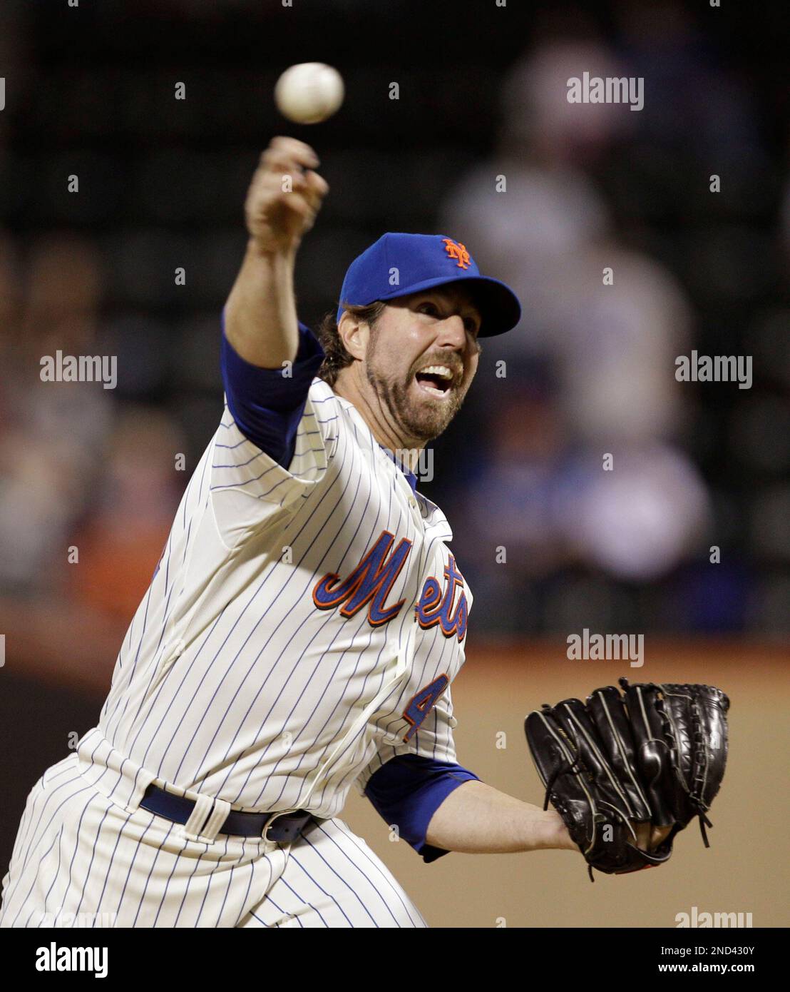 New York Mets starting pitcher R.A. Dickey delivers in the first inning ...