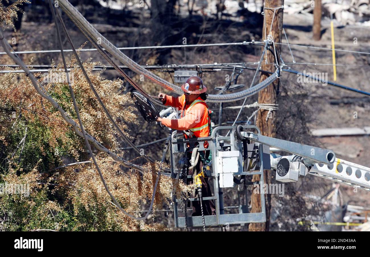 A utility worker works on power lines in San Bruno, Calif., Tuesday ...