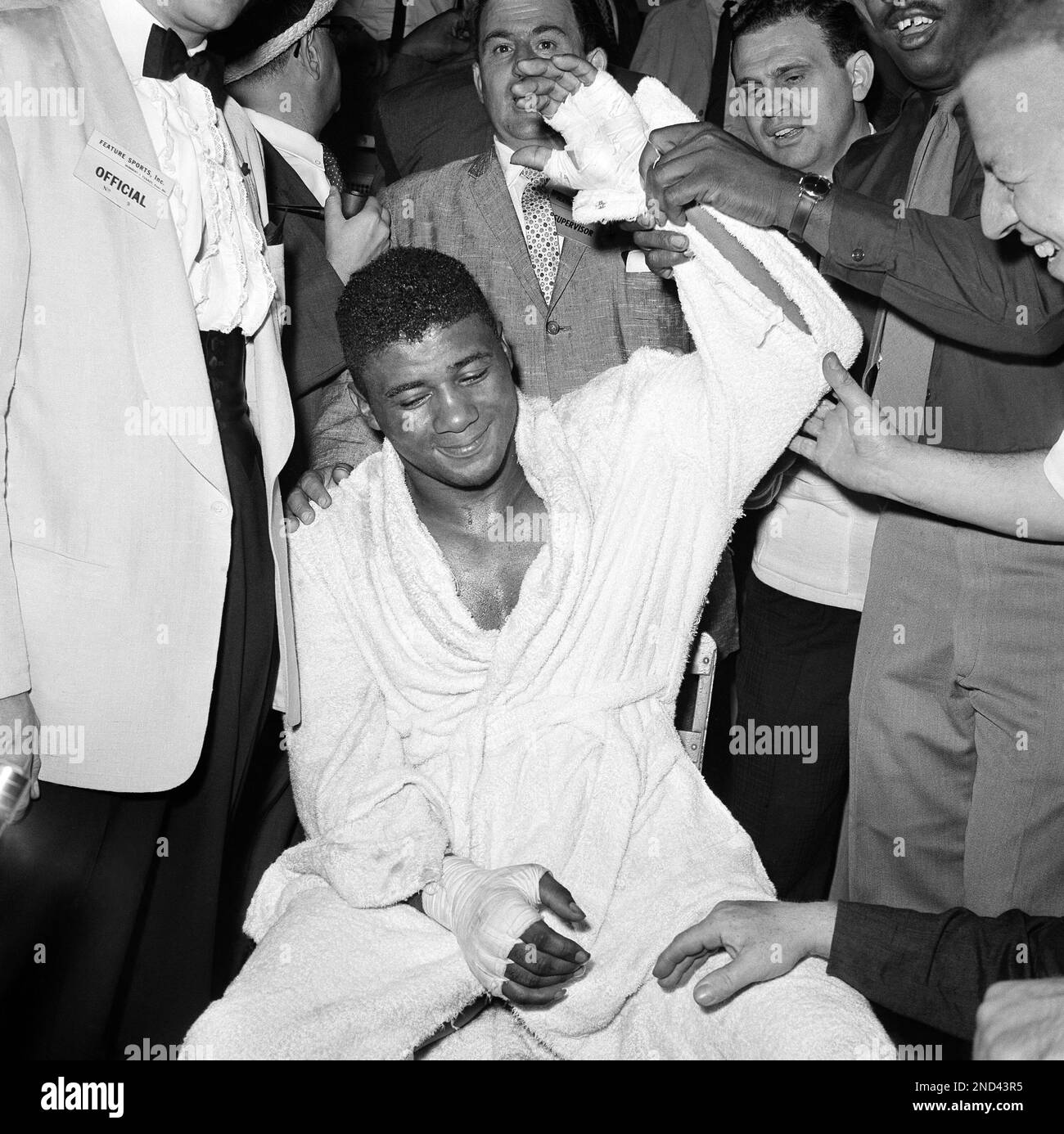 A smile appears on face of Floyd Patterson as his hand is raised in ...