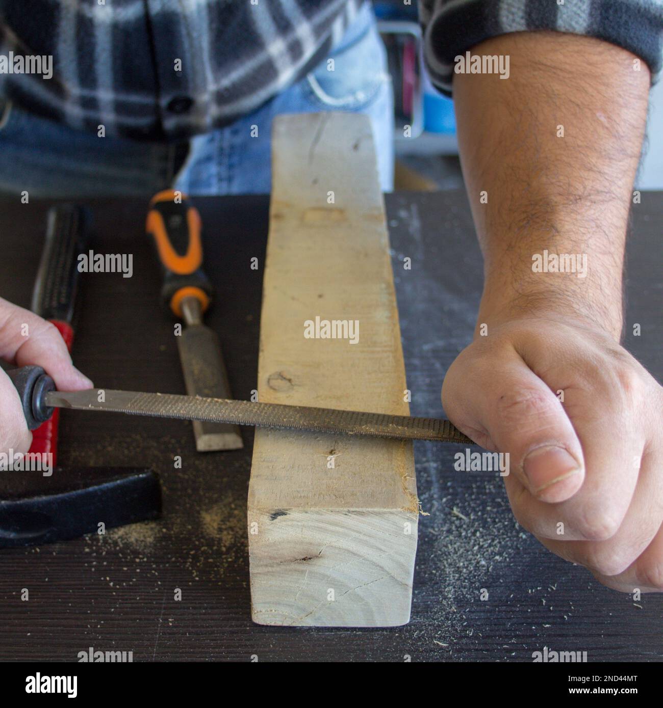 Image of the hands of a carpenter craftsman who smoothes a piece of ...