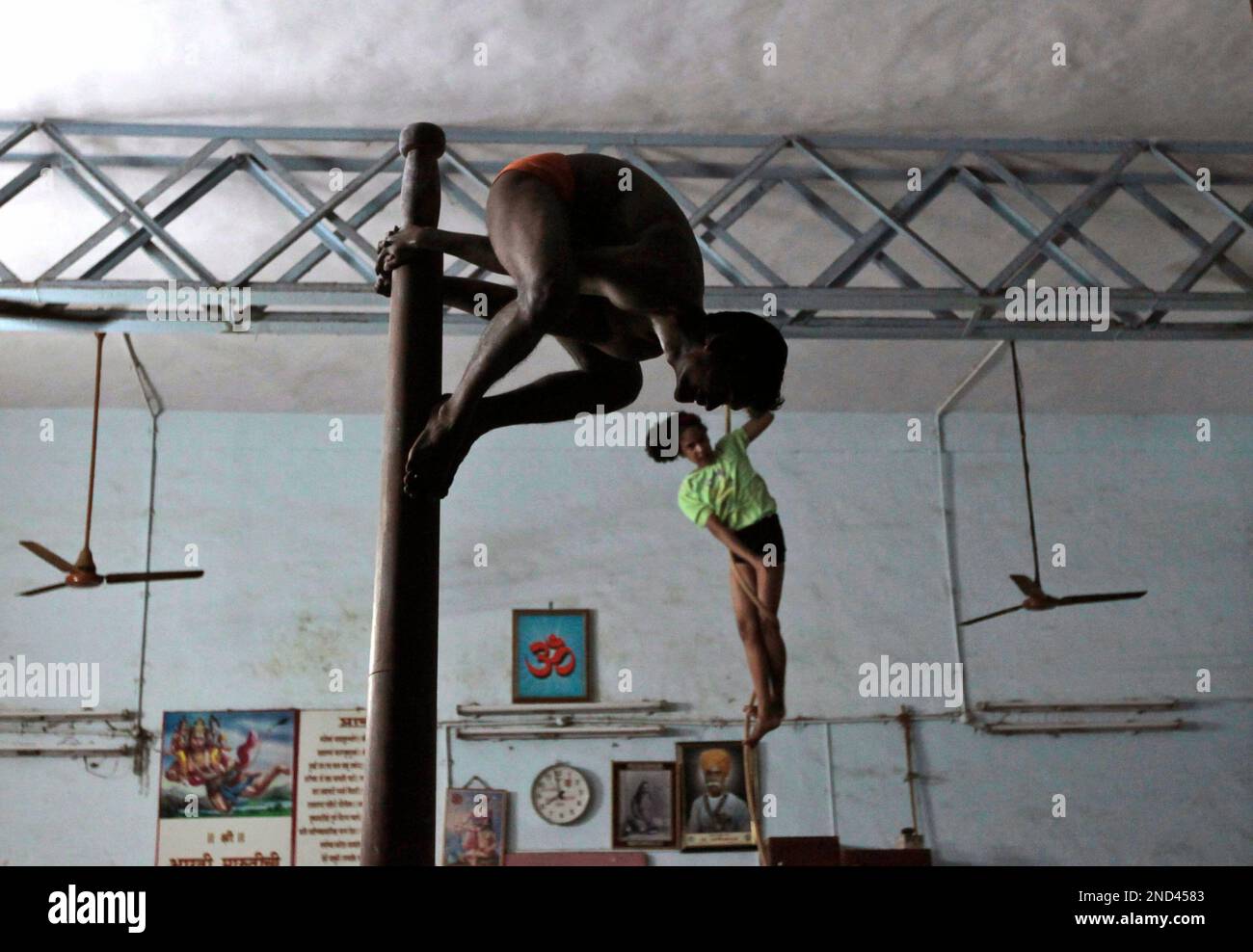 Indian gymnasts perform Mallakhamb at a gymnasium in Mumbai, India ...