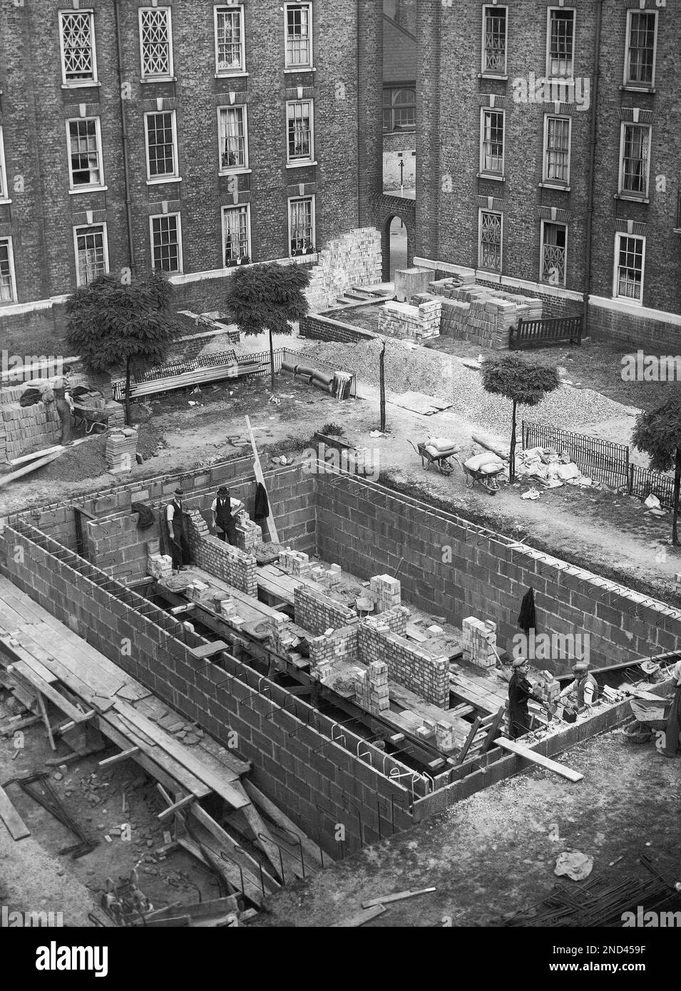 Building an air raid shelter of concrete and brick at a big block of ...