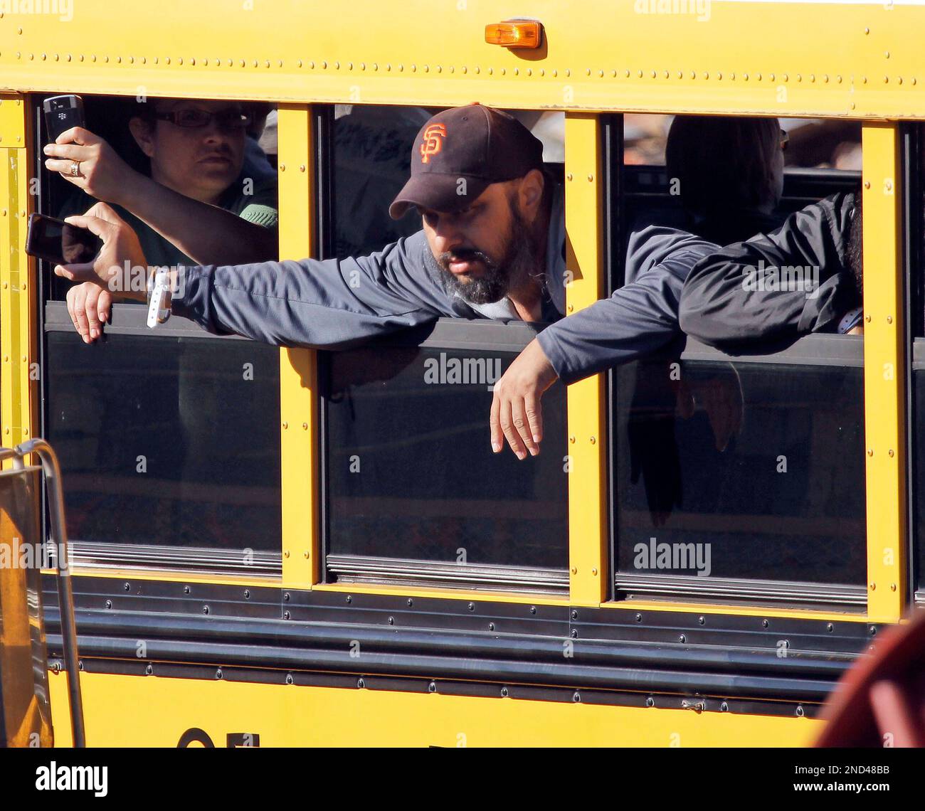 Residents look ou the window of a school bus as they are given a tour ...