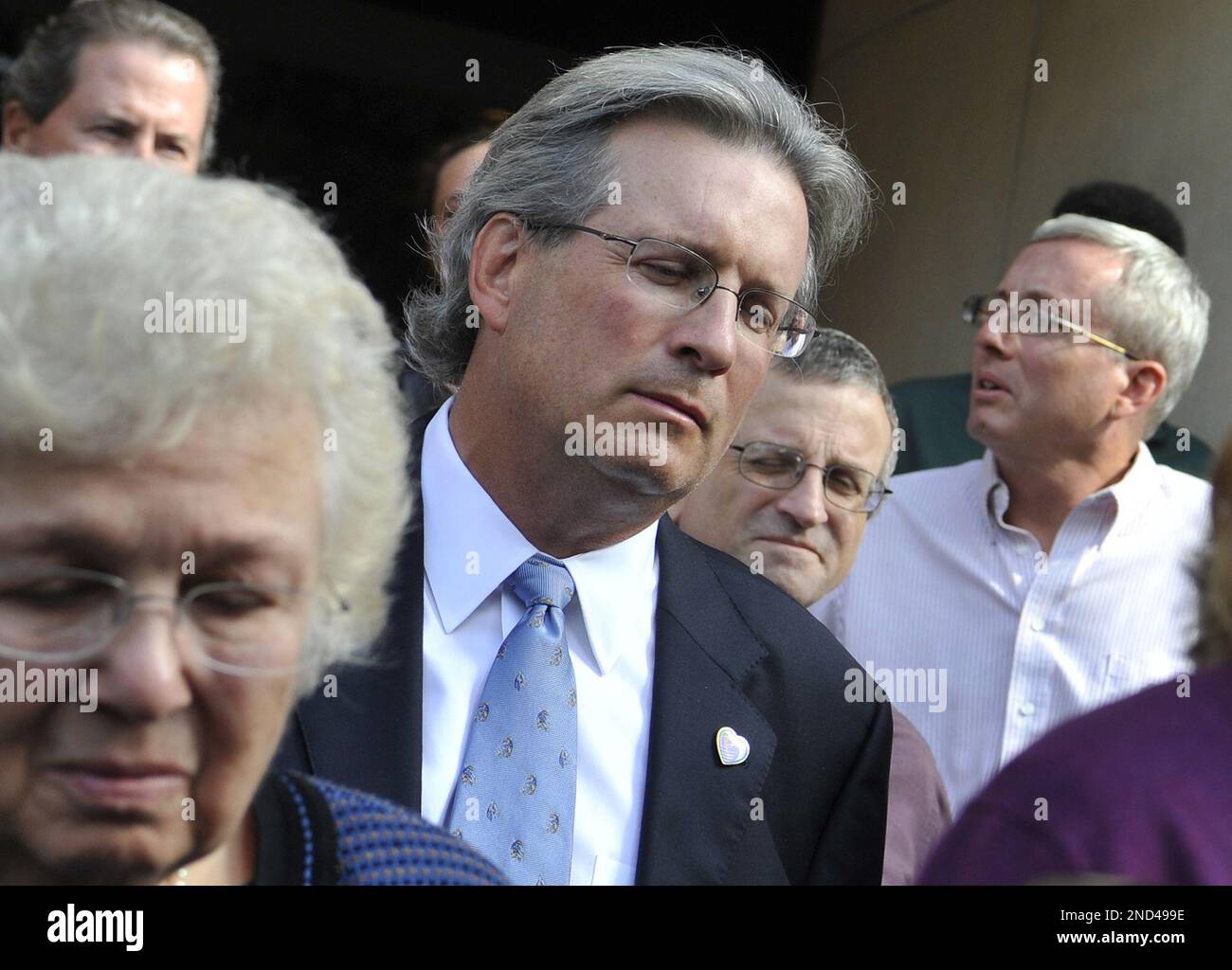 Dr. William Petit Jr., center, listens to a statement read to the media ...
