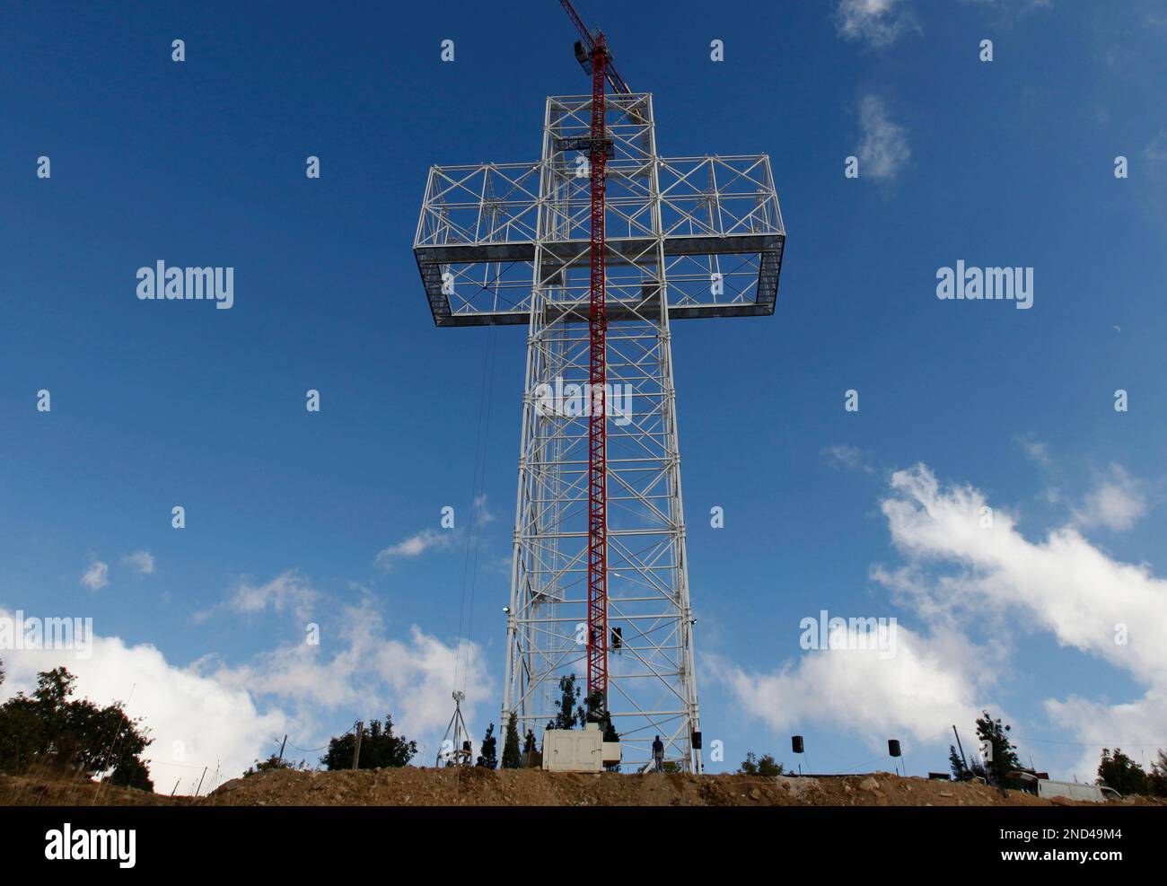 A towering cross is seen ready to be lit up on the eve of the feast of ...