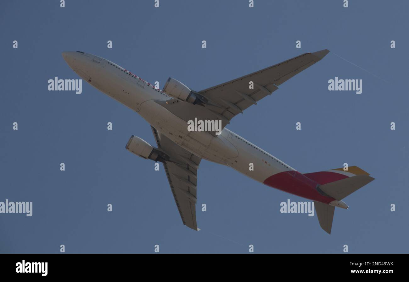 Plane ascending into the sky, flying, on its takeoff from the airport ...