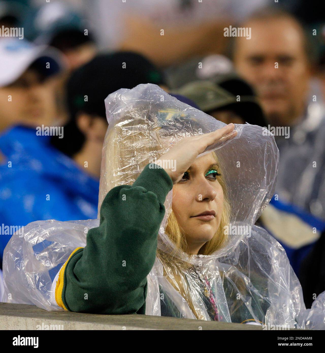 A Green Bay Packers fan watches from the stands in the rain during an ...