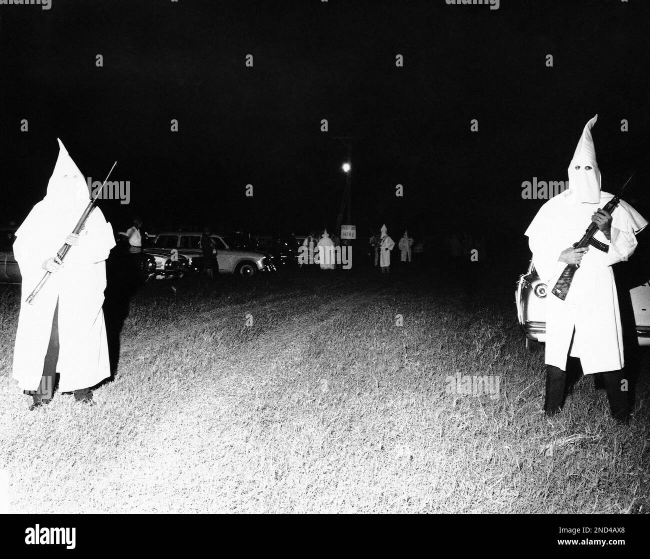 Two rifle-bearing Klansmen stand in a field near Pine Bluff, Arkansas ...