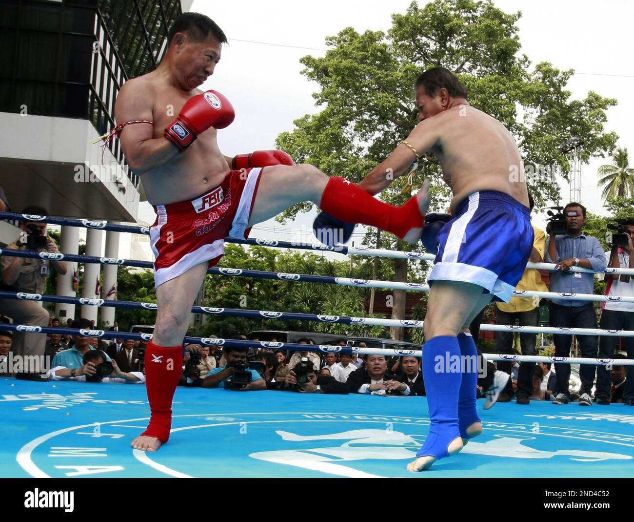 Thai boxers and senators Direk Tungfang, 64, left, kicks at Payap ...