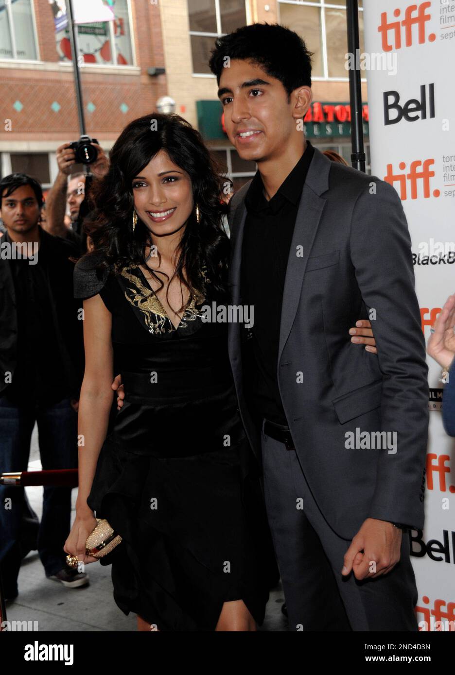 Actress Freida Pinto, left, and actor Dev Patel arrive at the premiere ...
