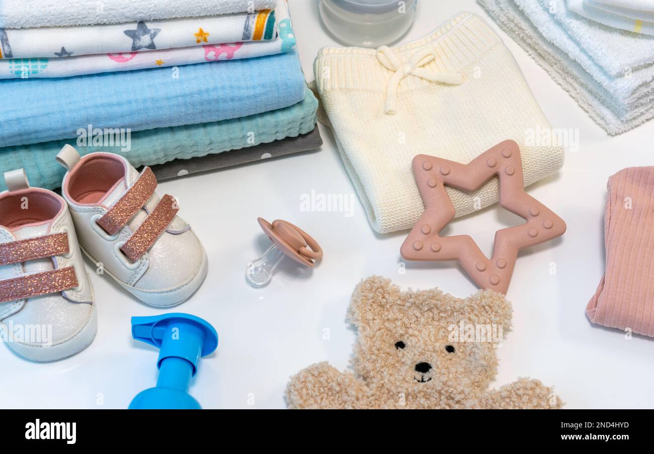 Concept of giving birth. Set of clothes and accessories for newborn on ...