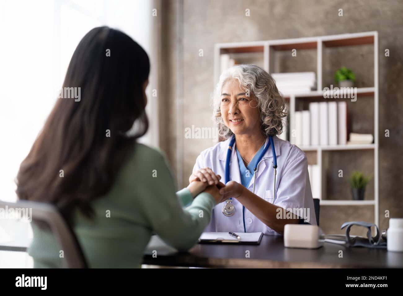 Woman senior doctor is Reading Medical History of Female Patient and ...