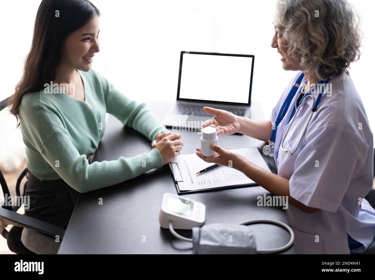 Woman senior doctor is Reading Medical History of Female Patient and ...