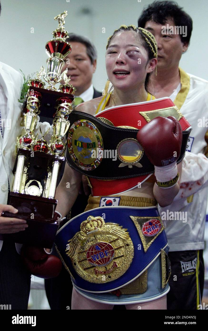 South Korea's Kim Ju-hee wearing her titles' belts celebrates after ...