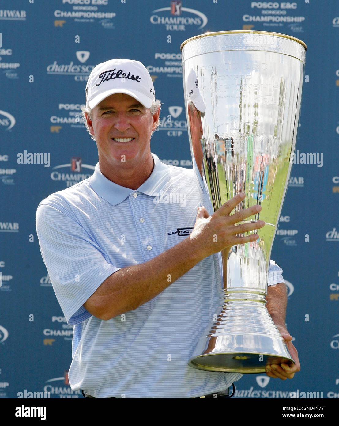 Russ Cochran of the United States holds the winner's trophy after the ...