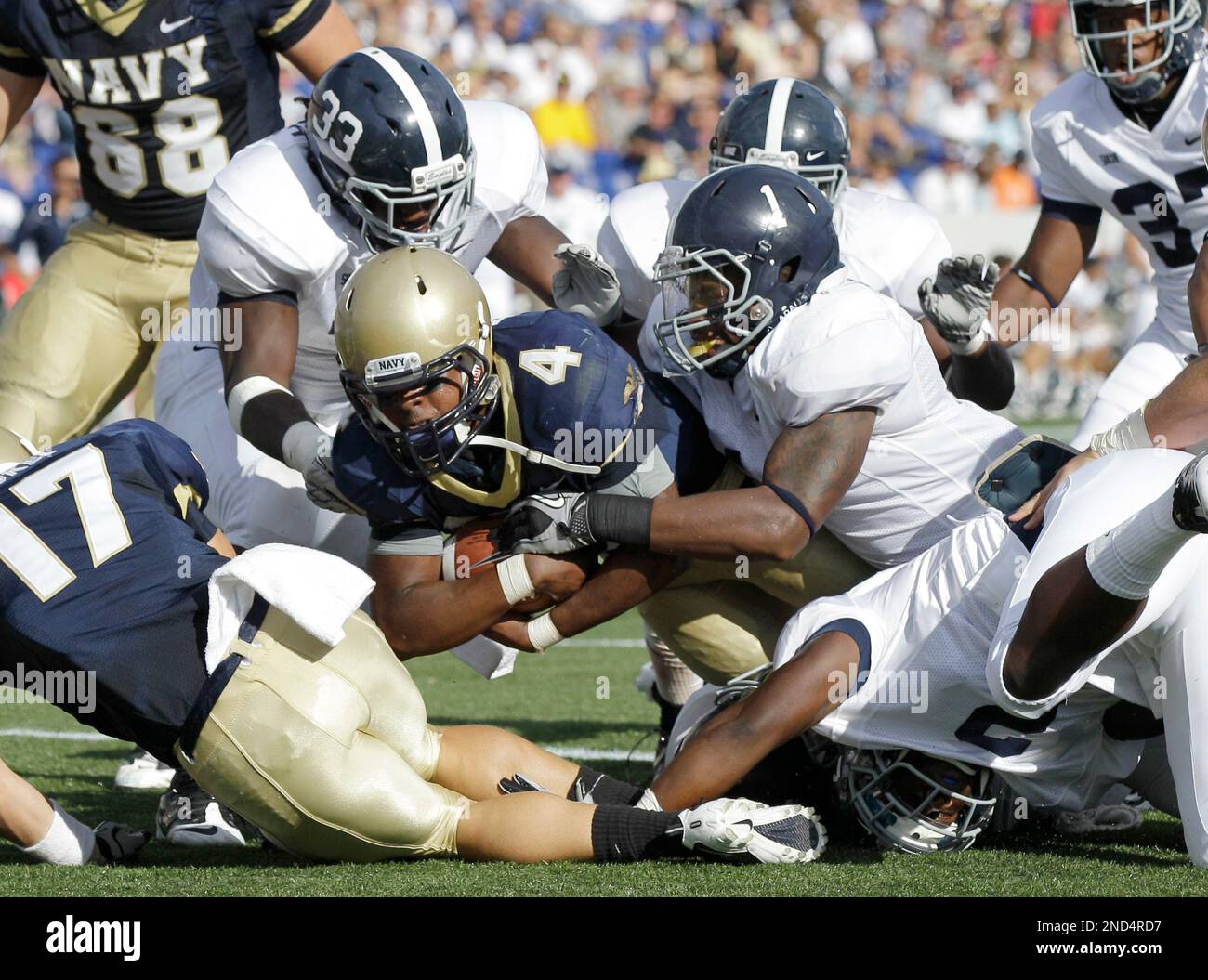 Navy quarterback Ricky Dobbs (4) is tackled by Georgia Southern's Dion ...