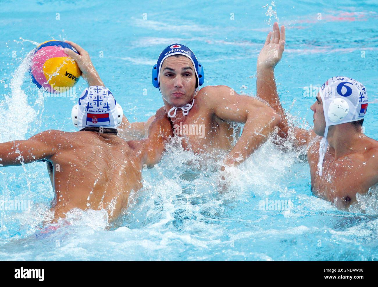 Serbia's players block Hungary's Daniel Rudolf Varga, center, during ...