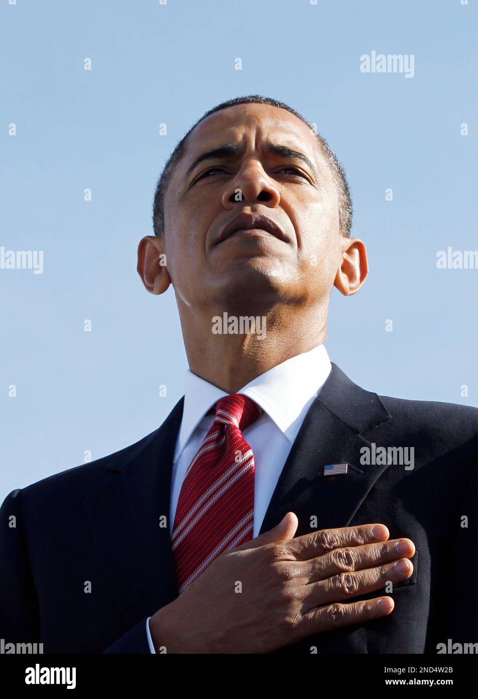 President Barack Obama puts his hand on his heart during the playing of ...