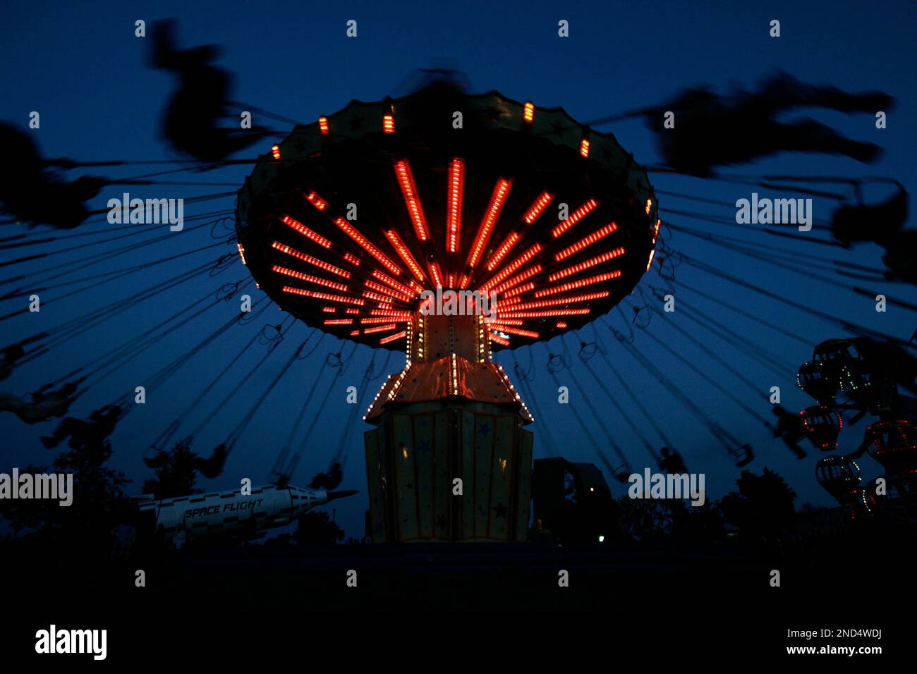 Pakistani Muslims enjoy a ride at a carnival as they celebrate Eid al ...