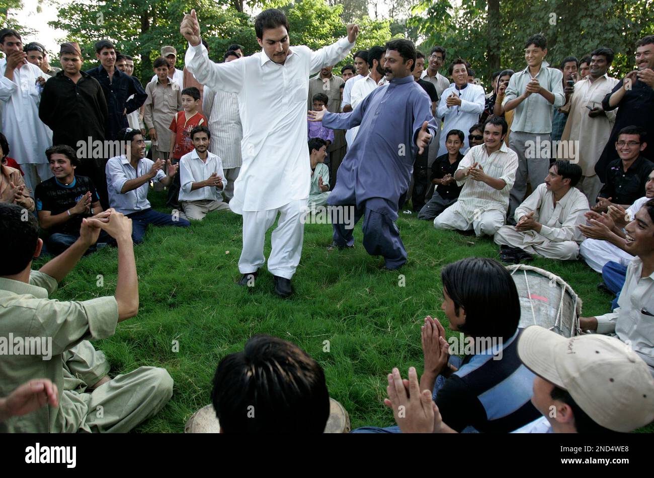 Pakistani Muslim men dance as they celebrate Eid al-Fitr at a park in ...