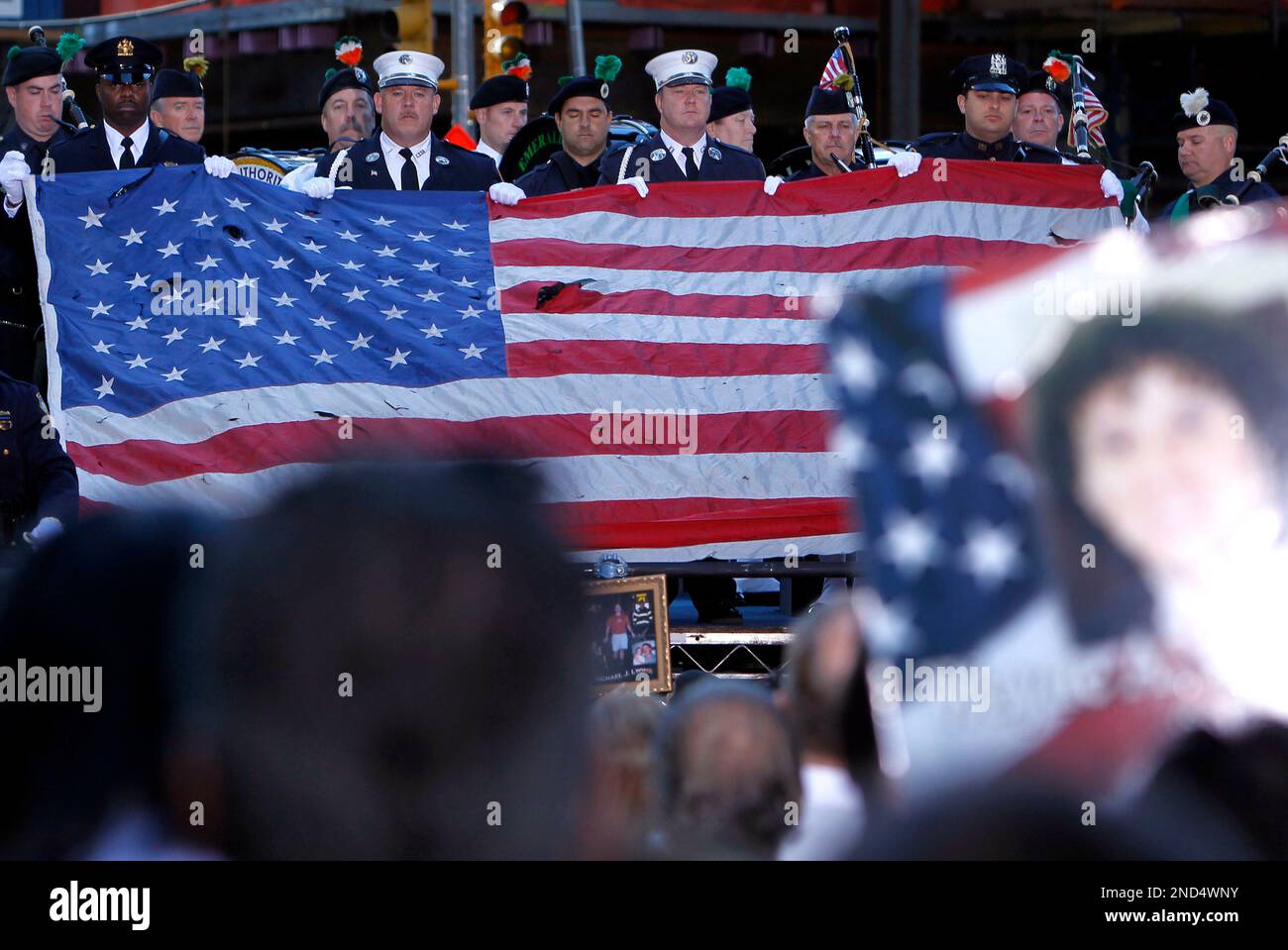 The World Trade Center flag is presented as friends and relatives of ...
