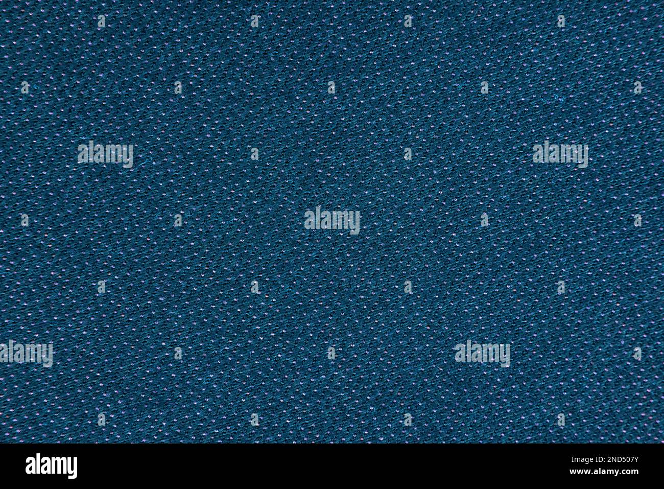 The background is made of blue material. Fabric for sewing clothes in a ...